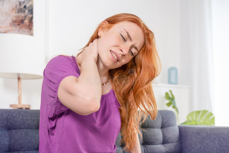 Woman Sitting on Couch Using Computer Suffers from Neck Pain Stock ...