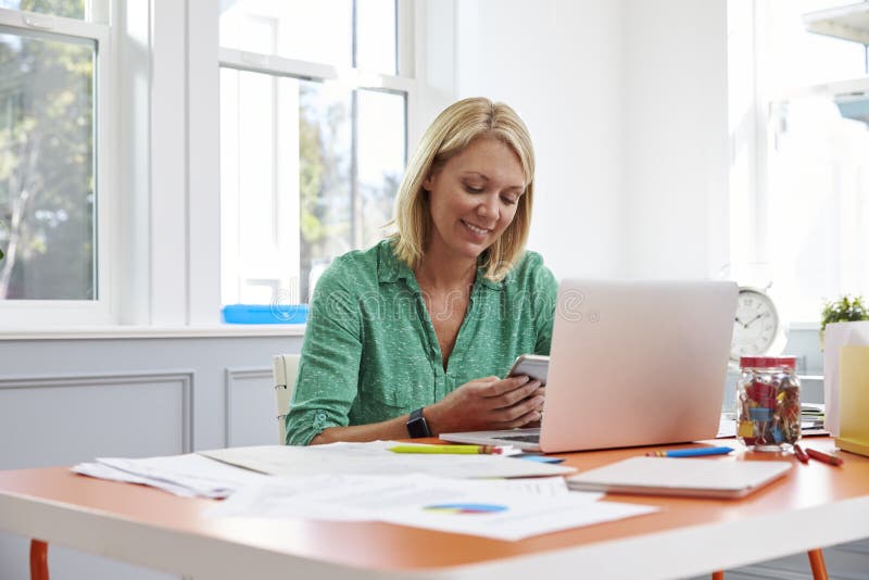 Woman Sitting at Desk Using Mobile Phone in Home Office Stock Image ...