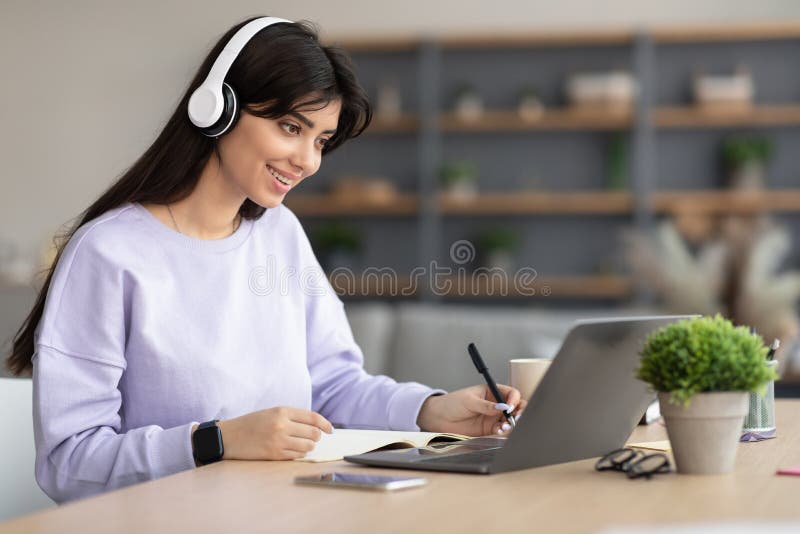 Woman Sitting at Desk, Using Pc and Writing in Notebook Stock Photo ...