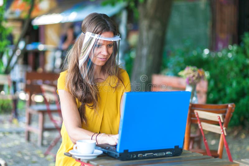 Woman Sitting in Empty Cafe Wearing Protective Visor Stock Image ...
