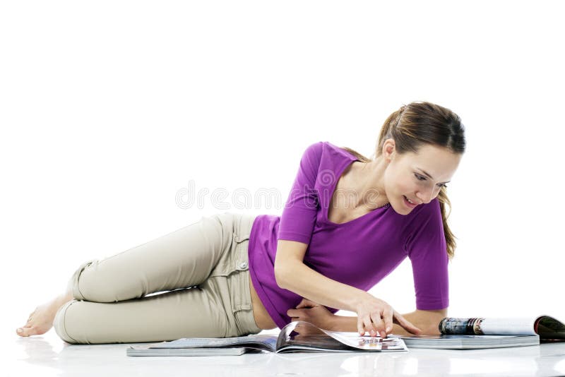 Young Woman Reading a Magazine Sitting on the Floor Stock Image - Image ...