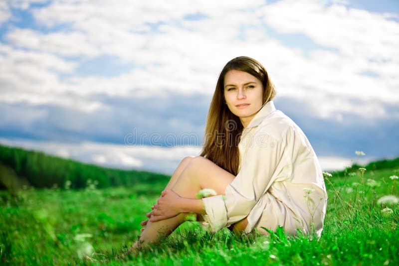 Woman sitting on the grass stock image. Image of scene - 11776687