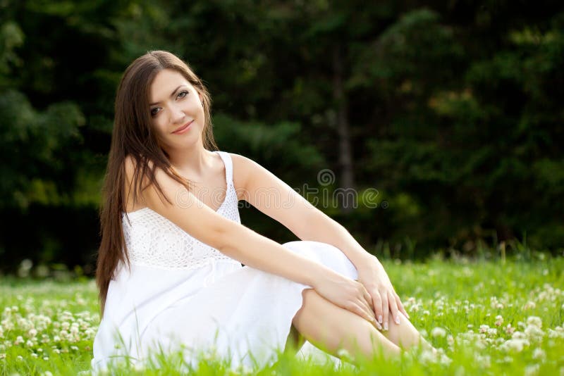 Woman sitting on grass stock image. Image of active, attractive - 21097631