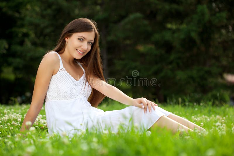 Woman sitting on grass stock photo. Image of lifestyle - 21097638
