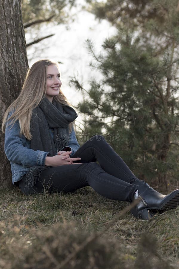 Woman Sitting on Ground Leaning Against Tree Stock Photo - Image of ...