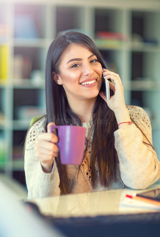 Woman Sitting in Home Office at Desk and Talking on Phone Stock Photo ...