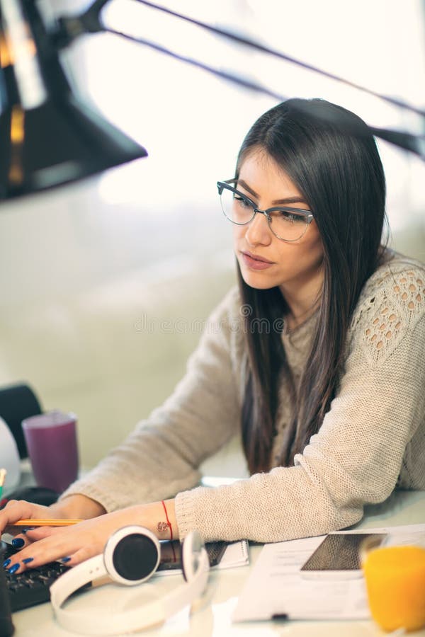 Woman Sitting in Home Office at Desk Working on Computer Stock Image ...