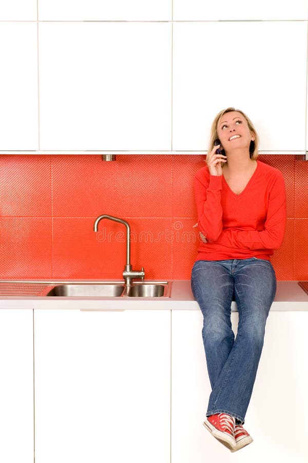 Woman Sitting on Kitchen Counter Stock Image - Image of woman ...