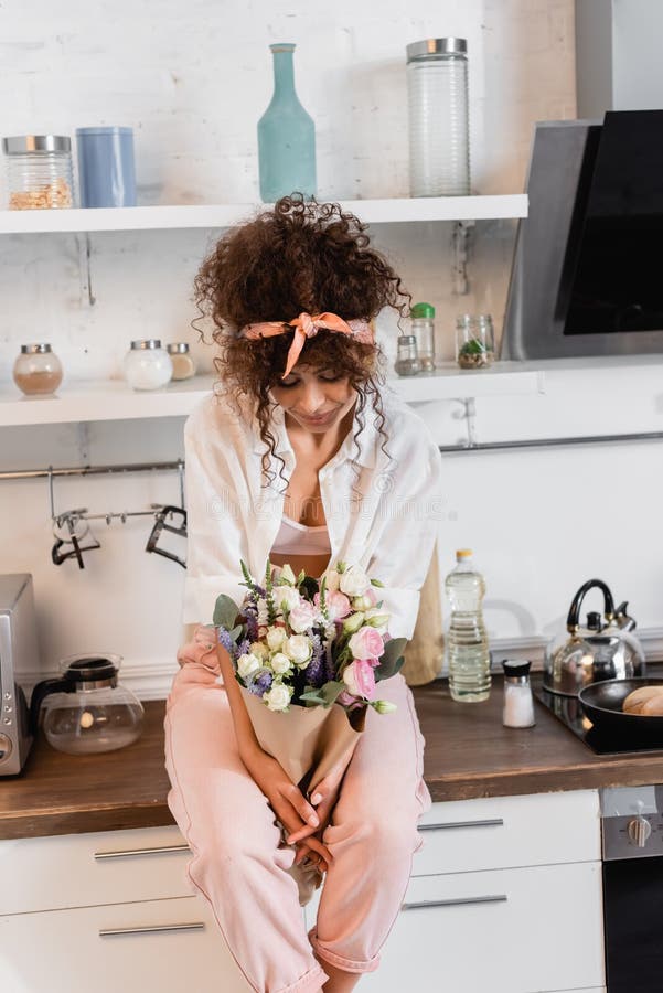 Woman Sitting on Kitchen Table and Stock Image - Image of woman ...