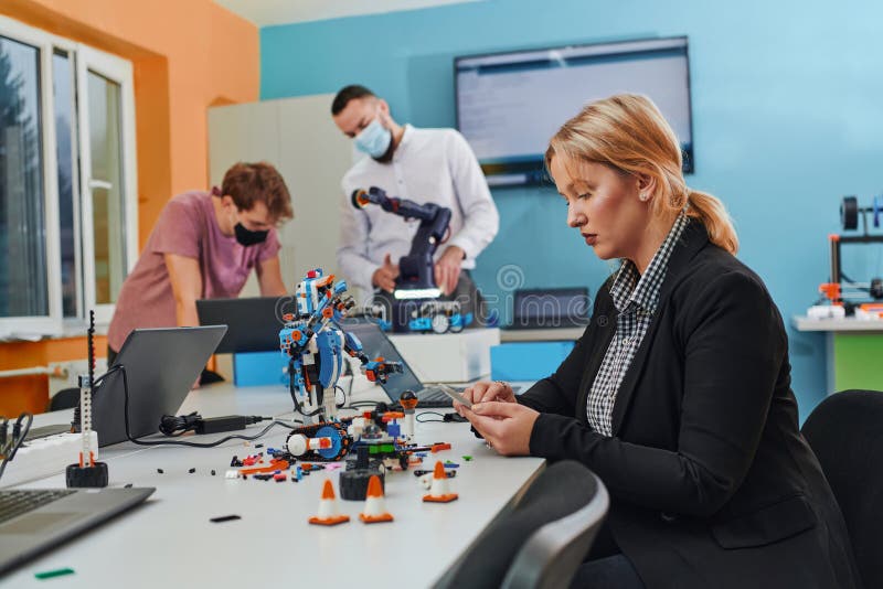 A Woman Sitting in a Laboratory and Solving Problems and Analyzing the ...