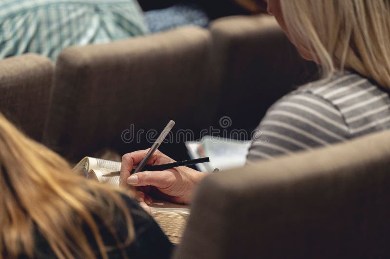 Woman Sitting in the Lecture Hall Taking Notes during Class. Stock ...