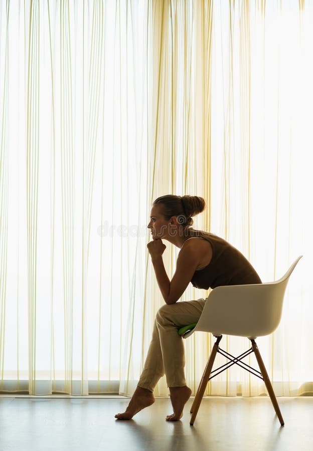 Woman Sitting Near Window in Thoughtful Pose Stock Image - Image of ...