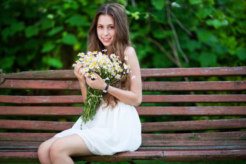 Woman Sitting on a Park Bench Stock Image - Image of dress, outdoor ...