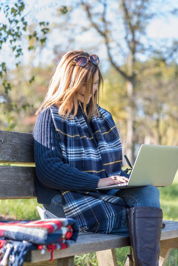 Woman Sitting on Park Bench with Laptop Computer Stock Photo - Image of ...