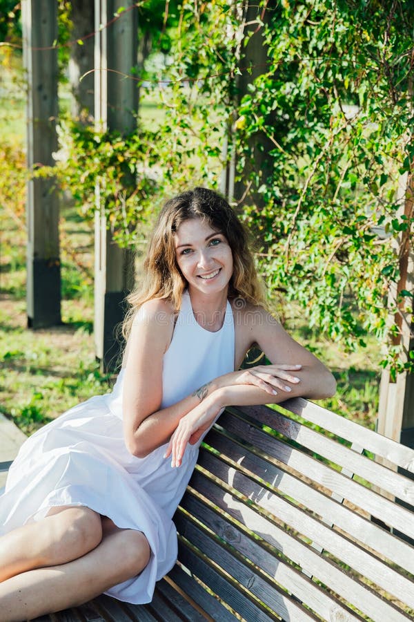 Bench for Rest in the Park between Two Flower Beds Stock Image - Image ...