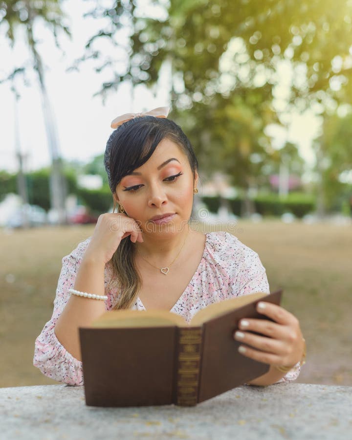 Woman Sitting at a Park Table Reading a Book. World Book Day Stock Image - Image of park, space ...