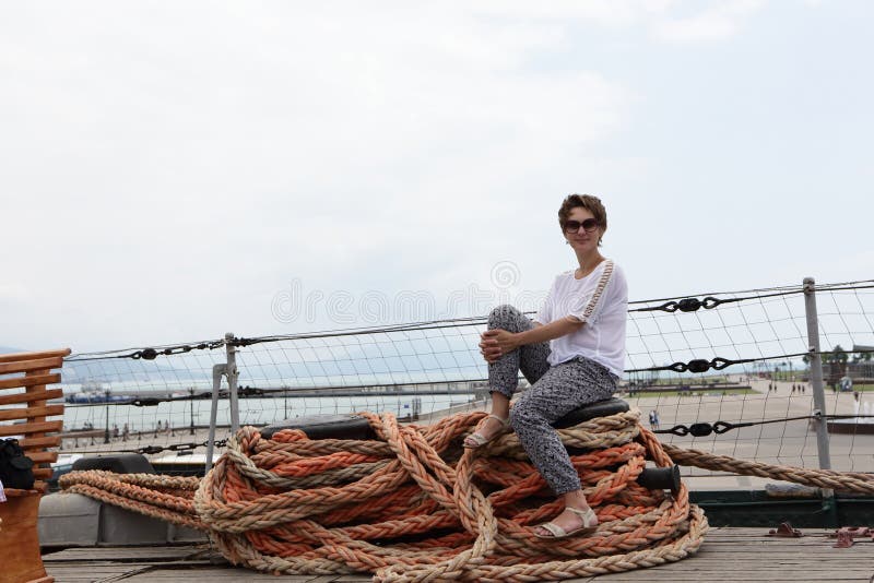 Woman sitting on rope stock photo. Image of knot, cord - 97873932