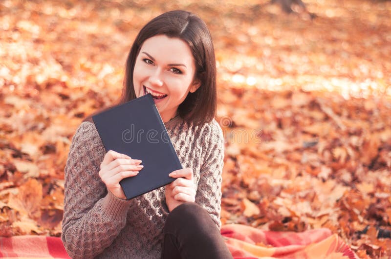 Woman Sitting on a Rug and Biting Book Stock Image - Image of fall ...