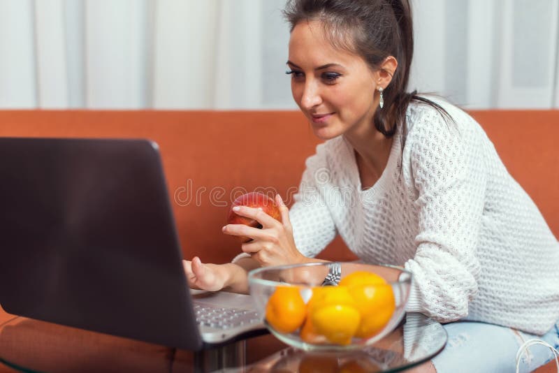 Woman Sitting on the Sofa Using a Laptop Computer at Home. Stock Image ...