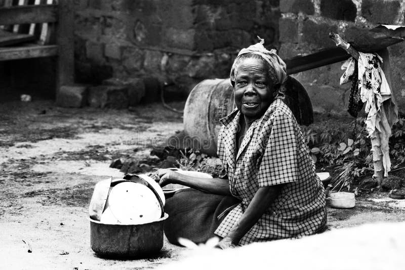 Woman Sitting On Soil Beside Cooking Pot Picture. Image: 114825486