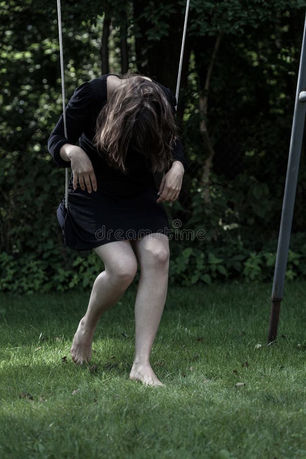 Woman Sitting on Swing with Her Head Down Stock Photo - Image of people ...