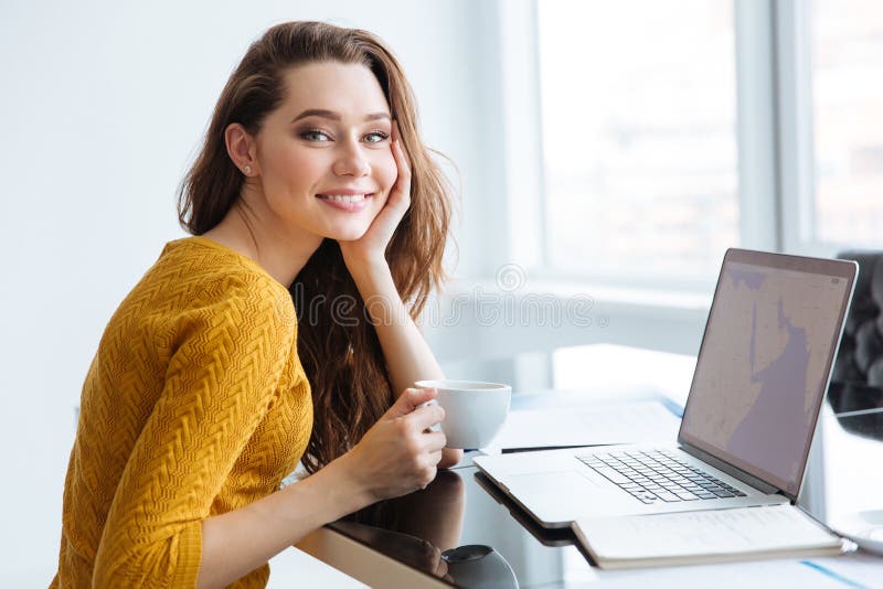Woman Sitting at the Table with Laptop and Drinking Tea Stock Image ...