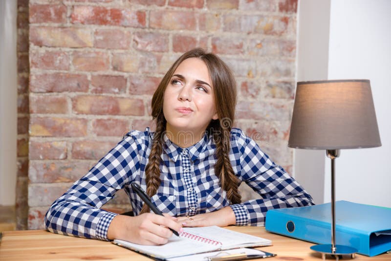 Woman Sitting at the Table and Thinking about Her Homework Stock Photo ...