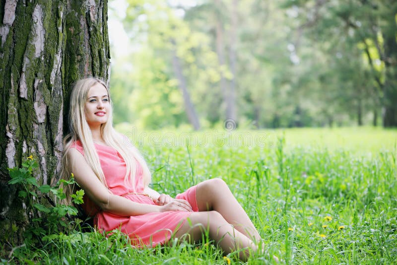 Woman sitting under a tree stock photo. Image of casual - 71562690
