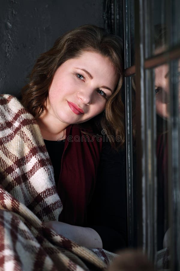 Woman Sitting by the Window Stock Photo - Image of closeup, pensive ...