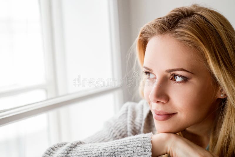 Woman Sitting on Window Sill, Looking Out of Window Stock Image - Image ...