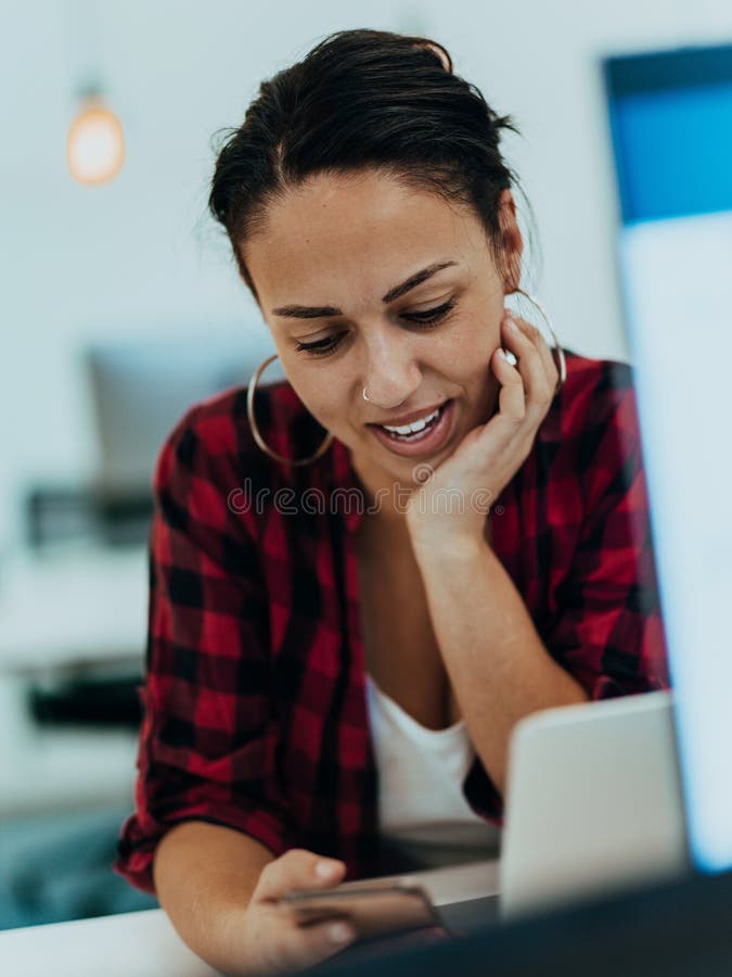 Woman Sitting at Workplace Desk Holds Smartphone Staring at Laptop ...