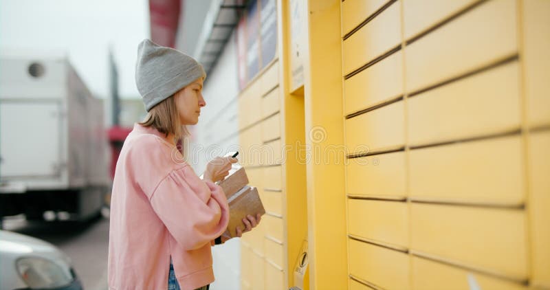 Woman Skans QR Code on Mobile Smartphone To Send Parcel with Locker ...