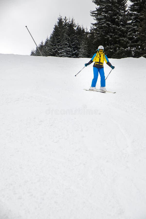 Woman skier on the slope stock image. Image of slope - 262115475