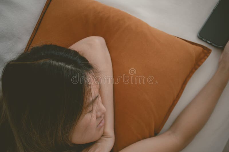 Woman Sleep on the Sofa with the Mobile Phone Still on Her Hand. Stock ...