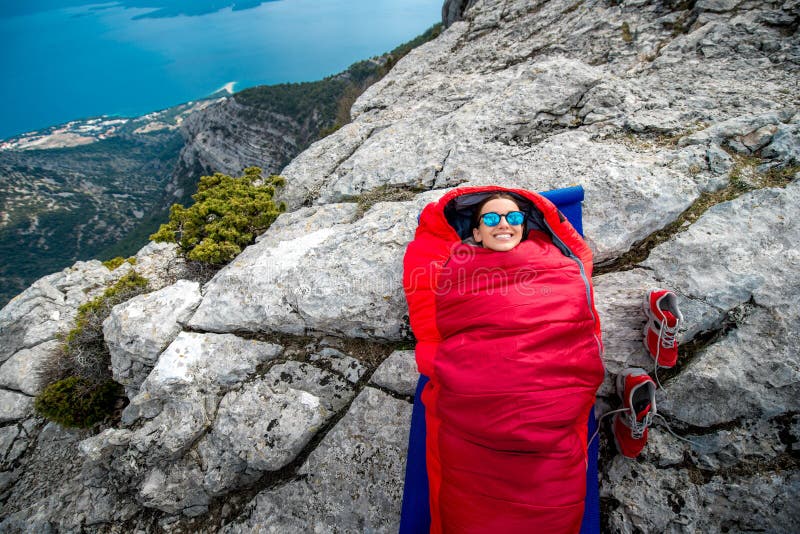 Woman in Sleeping Bag on the Mountain Stock Photo - Image of cliff ...