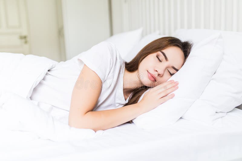 Woman Sleeping in Her Bed. Beautiful Young Smiling Woman Sleeping in ...