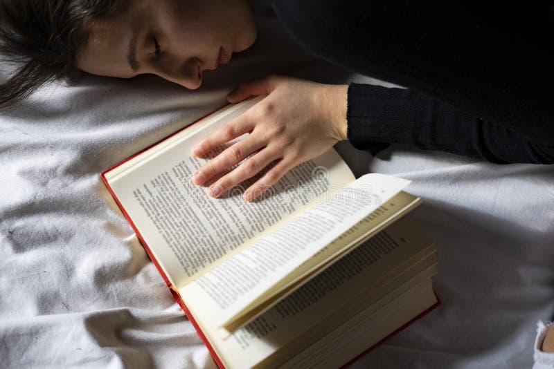 Woman Sleeping Next To an Open Book Stock Photo - Image of sleeping ...