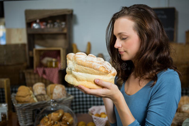 Woman Smelling Bread at Bakery Counter Stock Photo - Image of holding ...
