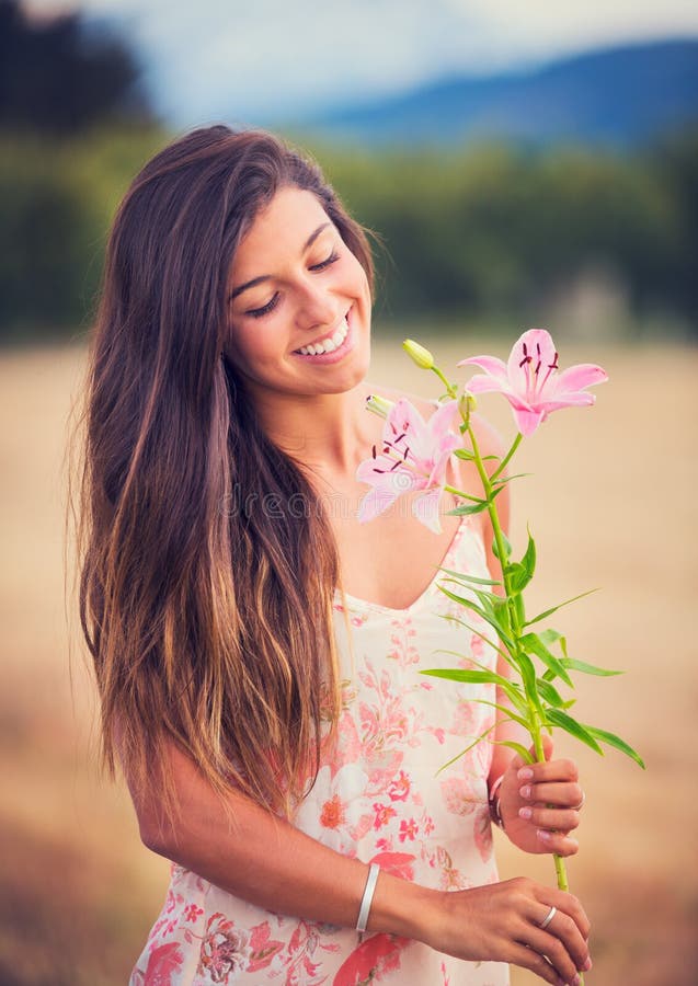 Woman Smelling Flowers in Nature Stock Photo - Image of summer ...