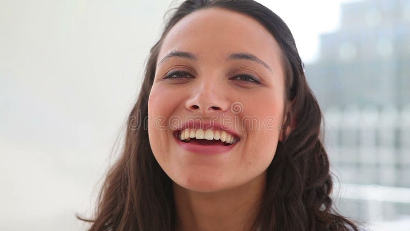 Woman smiling as she talks stock footage. Video of joyful - 43097422