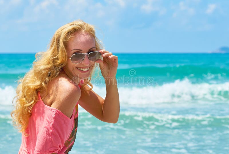 Woman smiling at the beach stock photo. Image of girl - 54961700