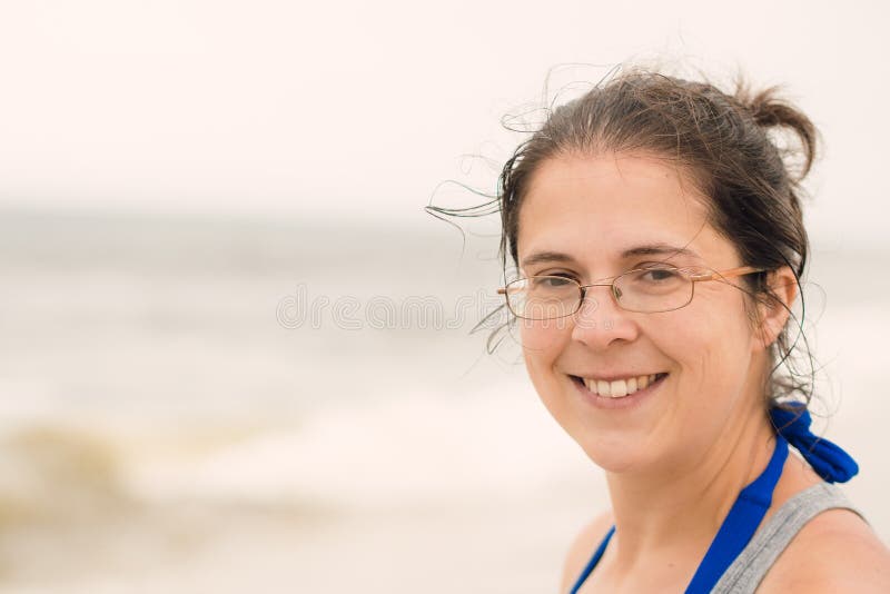 Woman smiling on the beach stock photo. Image of standing - 41034346