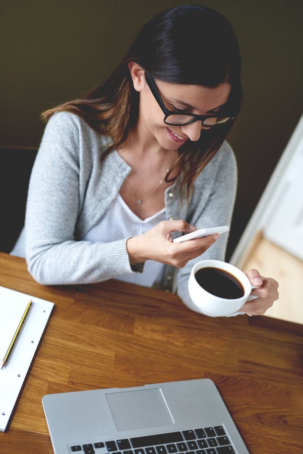 Woman Smiling while Checking Phone and Drinking Coffee Stock Photo ... Woman Smiling while Checking Phone and Drinking Coffee Stock Photo ...
