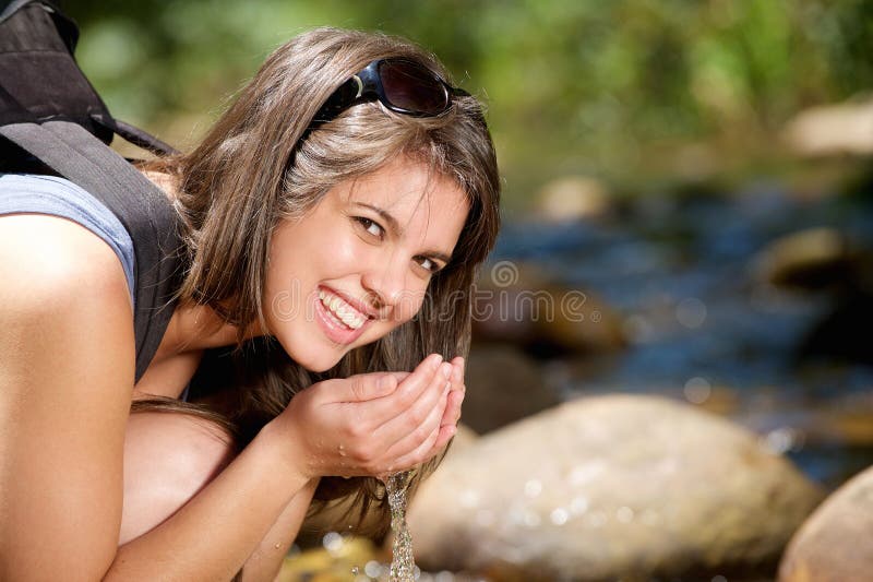 Woman Drinking Water from Outdoor Stream with Her Hands Stock Photo ...