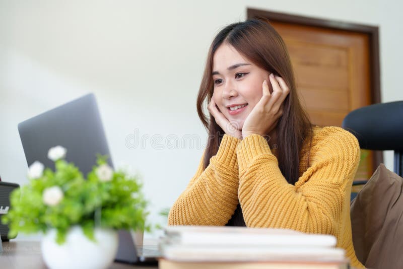 Woman Smiling Happily while Using Computer at Home Stock Photo - Image ...