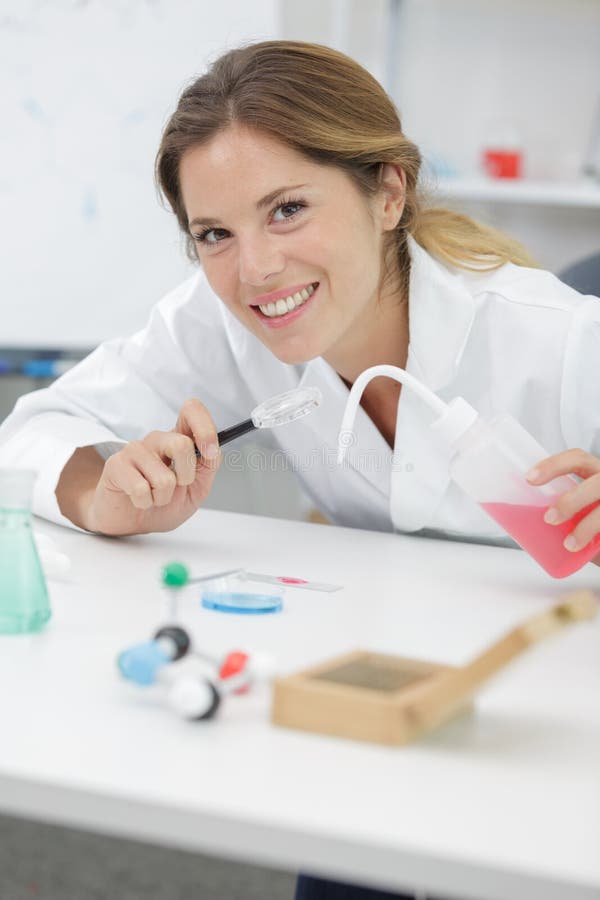 Woman Smiling while Looking at Test Tube Stock Image - Image of ...