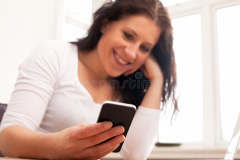 Woman Smiling while Reading Text Message Stock Photo - Image of network ...