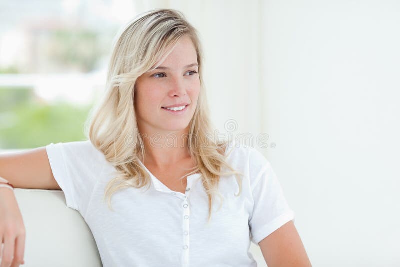 A Woman Smiling Slightly As she Looks Off To the Side Stock Image ...