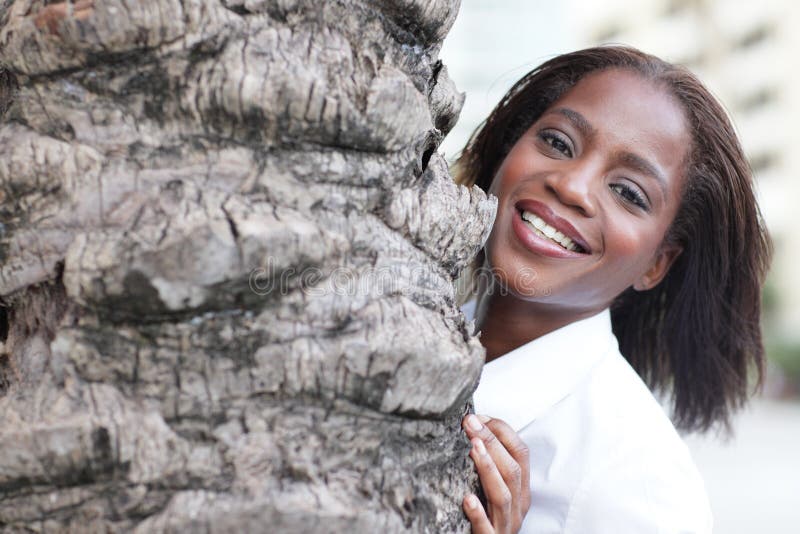 Woman smiling by a tree stock photo. Image of young, composition - 18543436