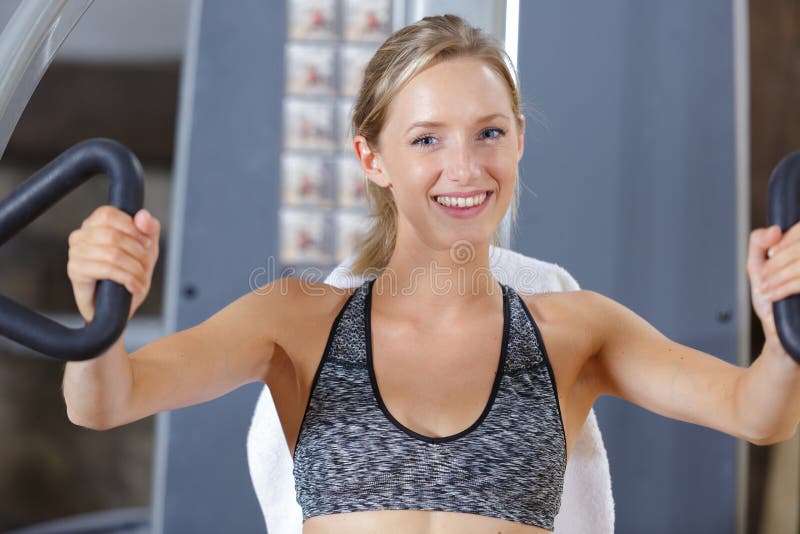 Woman Smiling while Using Gym Machine Stock Image - Image of sportswear ...